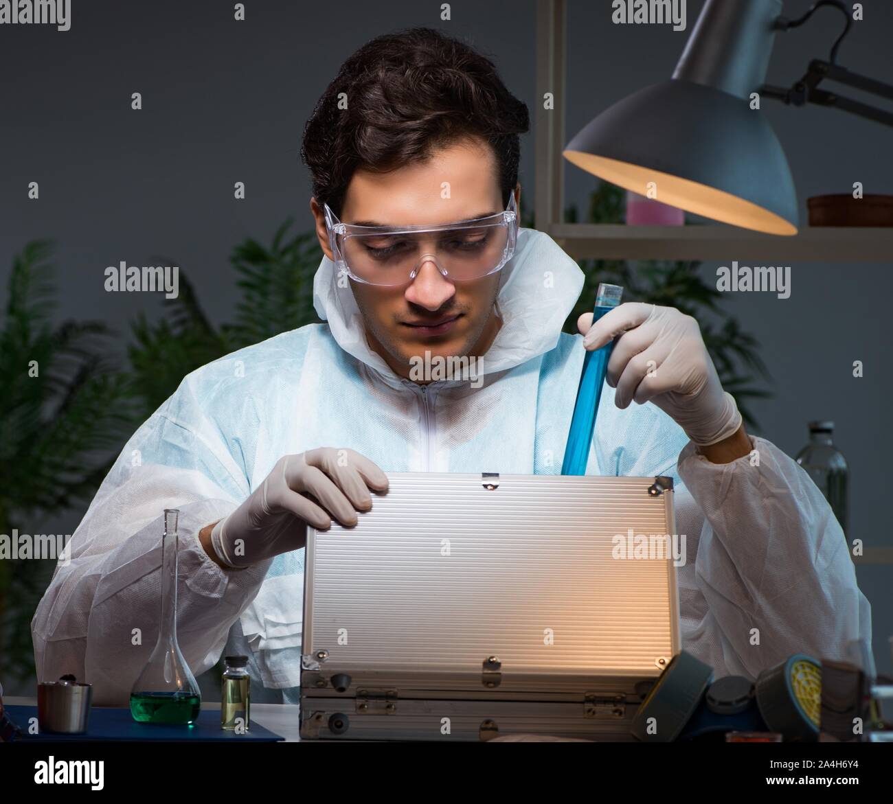 The forensic investigator working in lab looking for evidence Stock ...