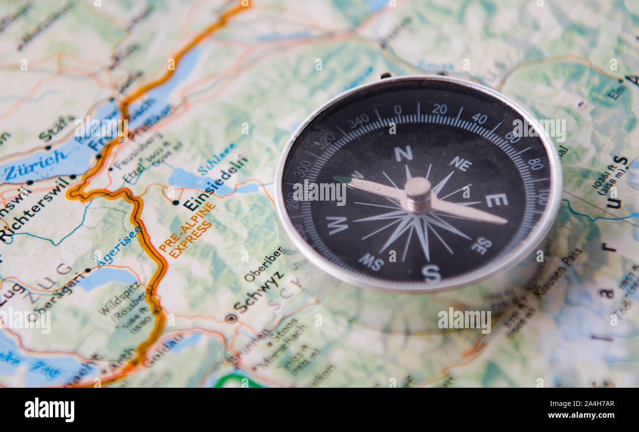 The travel concept with compass and map Stock Photo - Alamy