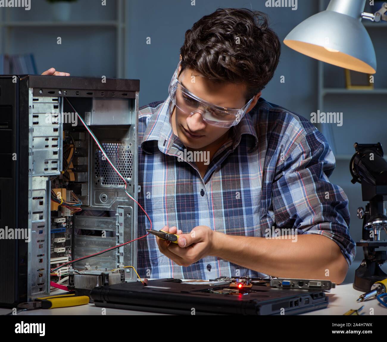 The man repairing computer desktop with pliers Stock Photo - Alamy