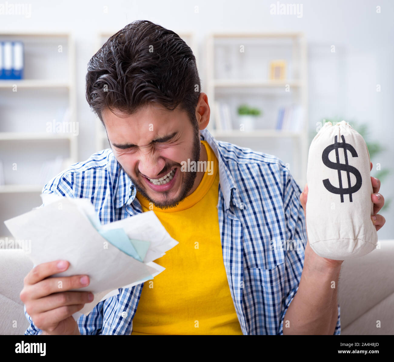 The man angry at bills he needs to pay Stock Photo - Alamy