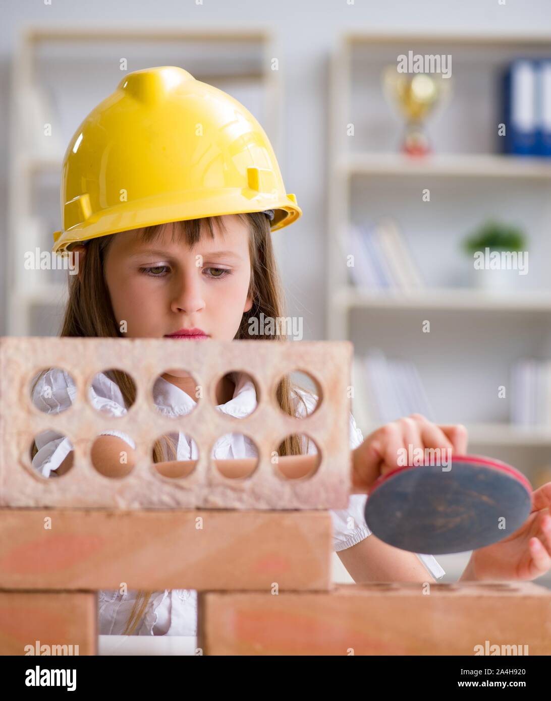 The young girl building with construction bricks Stock Photo - Alamy