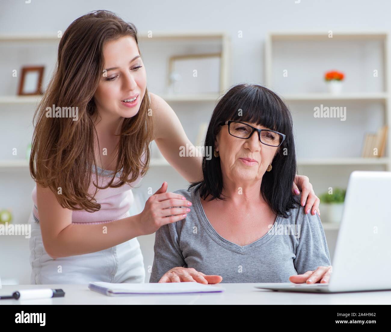The daughter explaining to mom how to use computer Stock Photo - Alamy