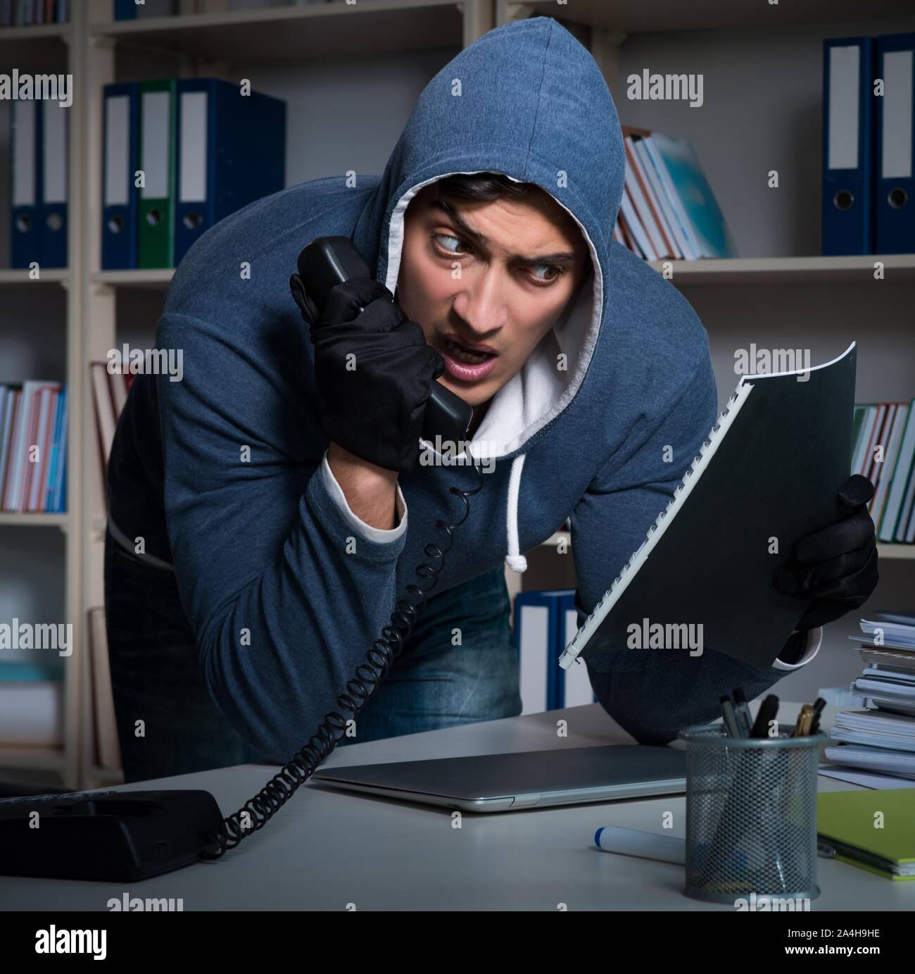 The young man in industrial espionage concept Stock Photo - Alamy