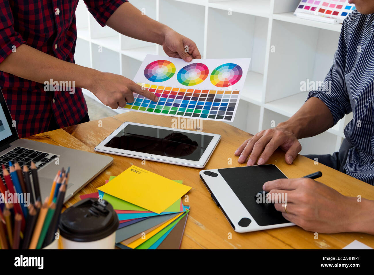 Graphic designers present colors from the color palette to their ...