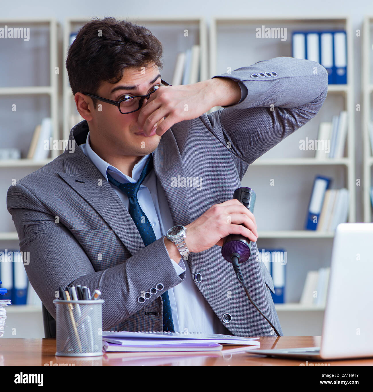 Businessman sweating excessively smelling bad in office at workplace ...