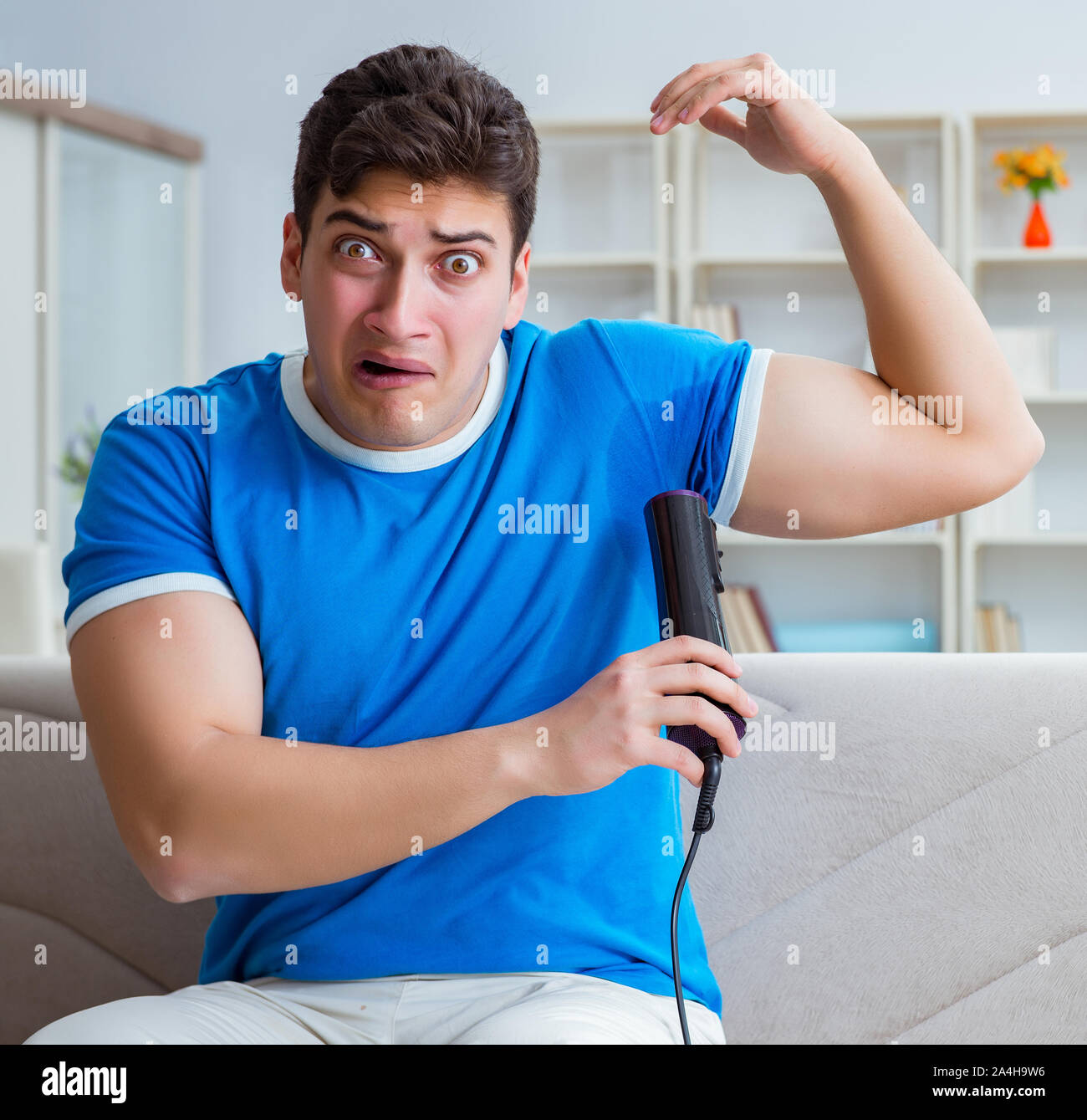 The man sweating excessively smelling bad at home Stock Photo - Alamy