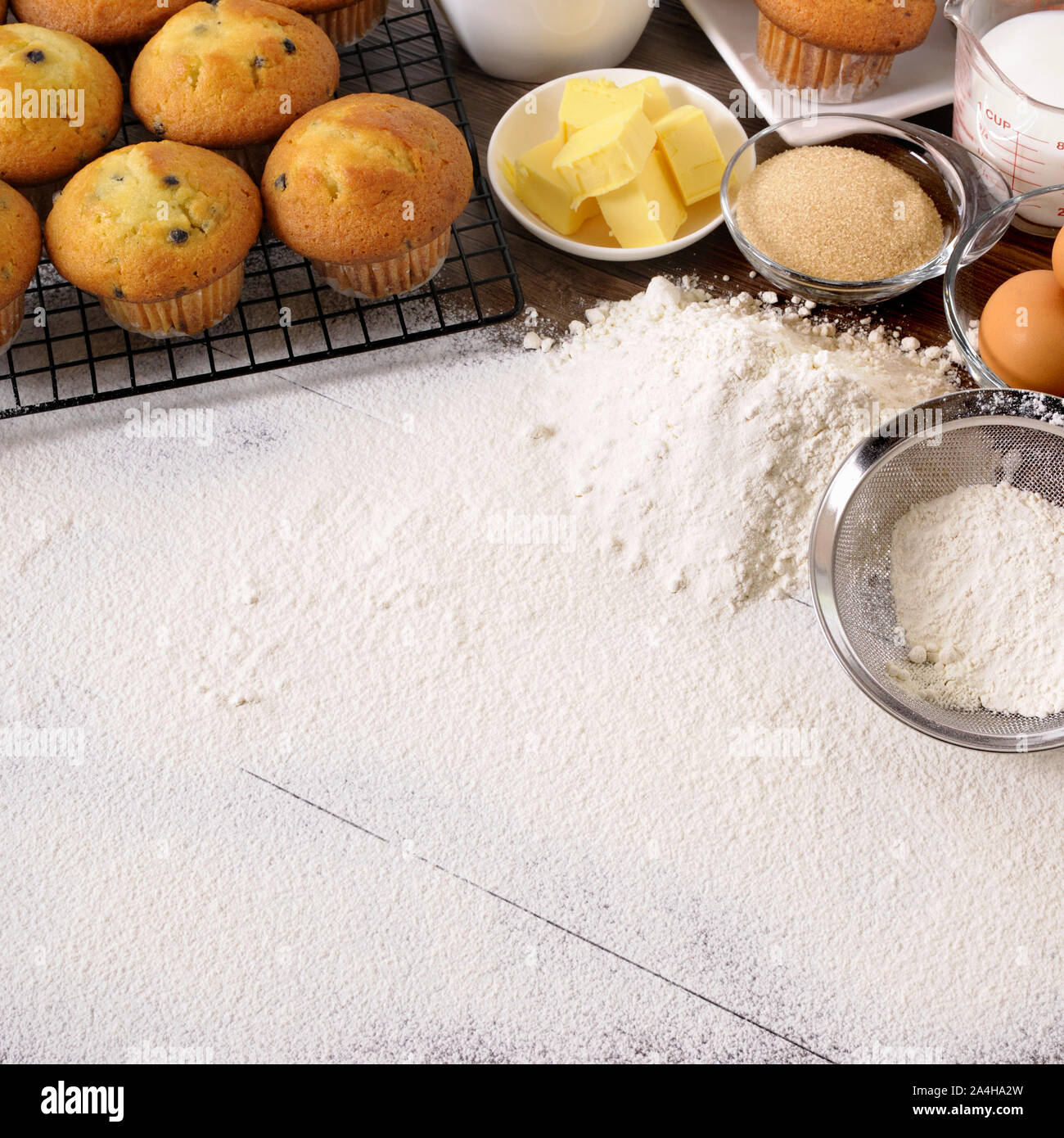 Baking background with dusted flour on a dark wood table with freshly ...