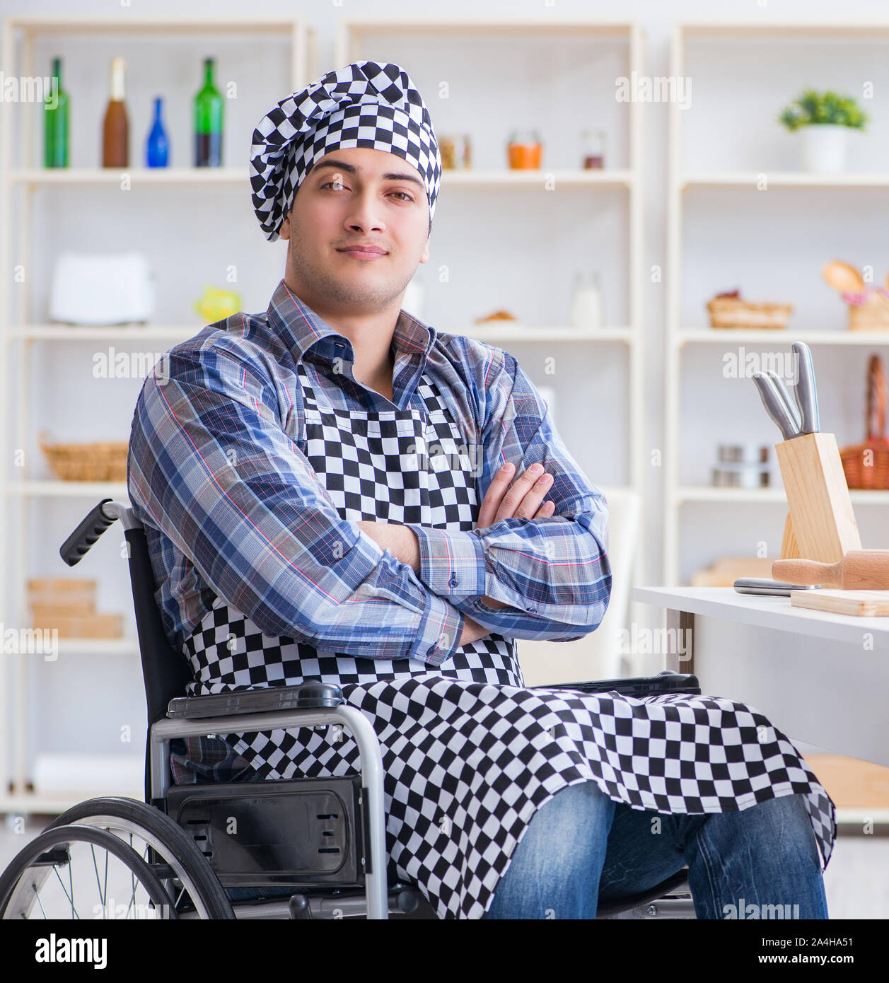 The disabled young husband frying at kitchen Stock Photo - Alamy