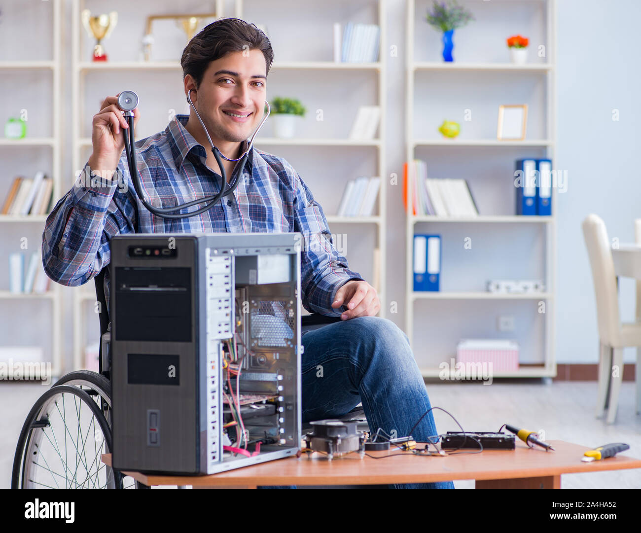 The computer repairman on wheelchair working Stock Photo - Alamy