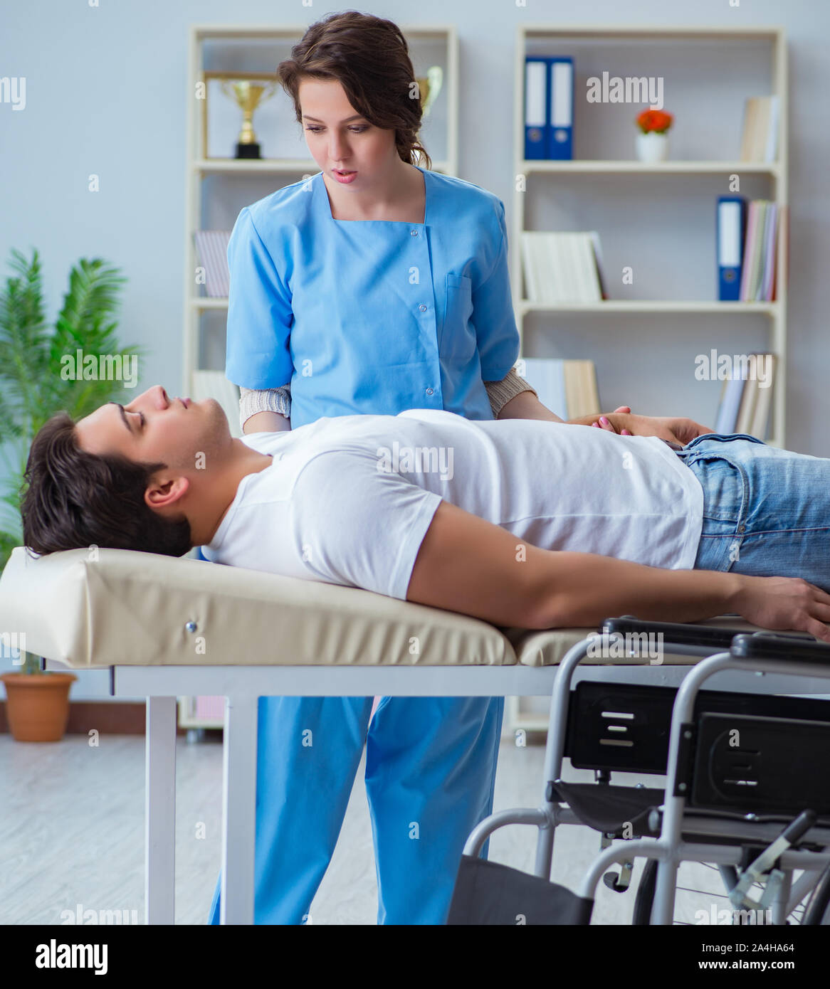 The patient undergoing rehabilitation recovery programme with doctor ...