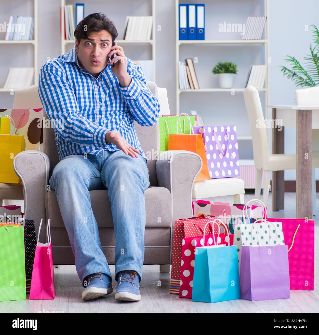 The young man after excessive shopping at home Stock Photo - Alamy