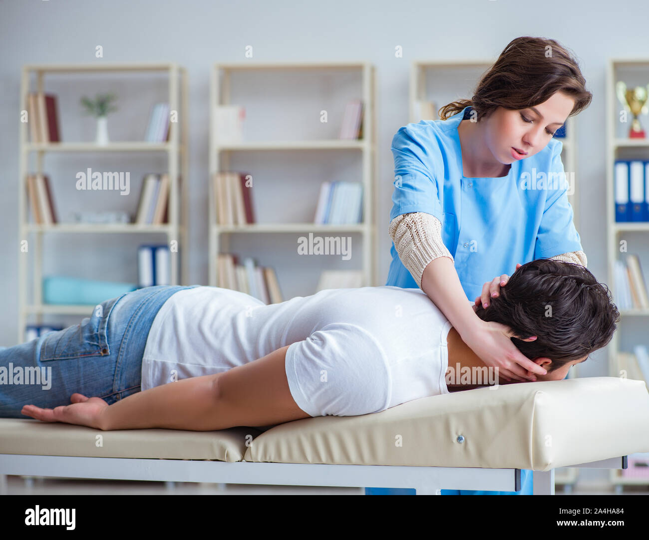 The female chiropractor doctor massaging male patient Stock Photo - Alamy