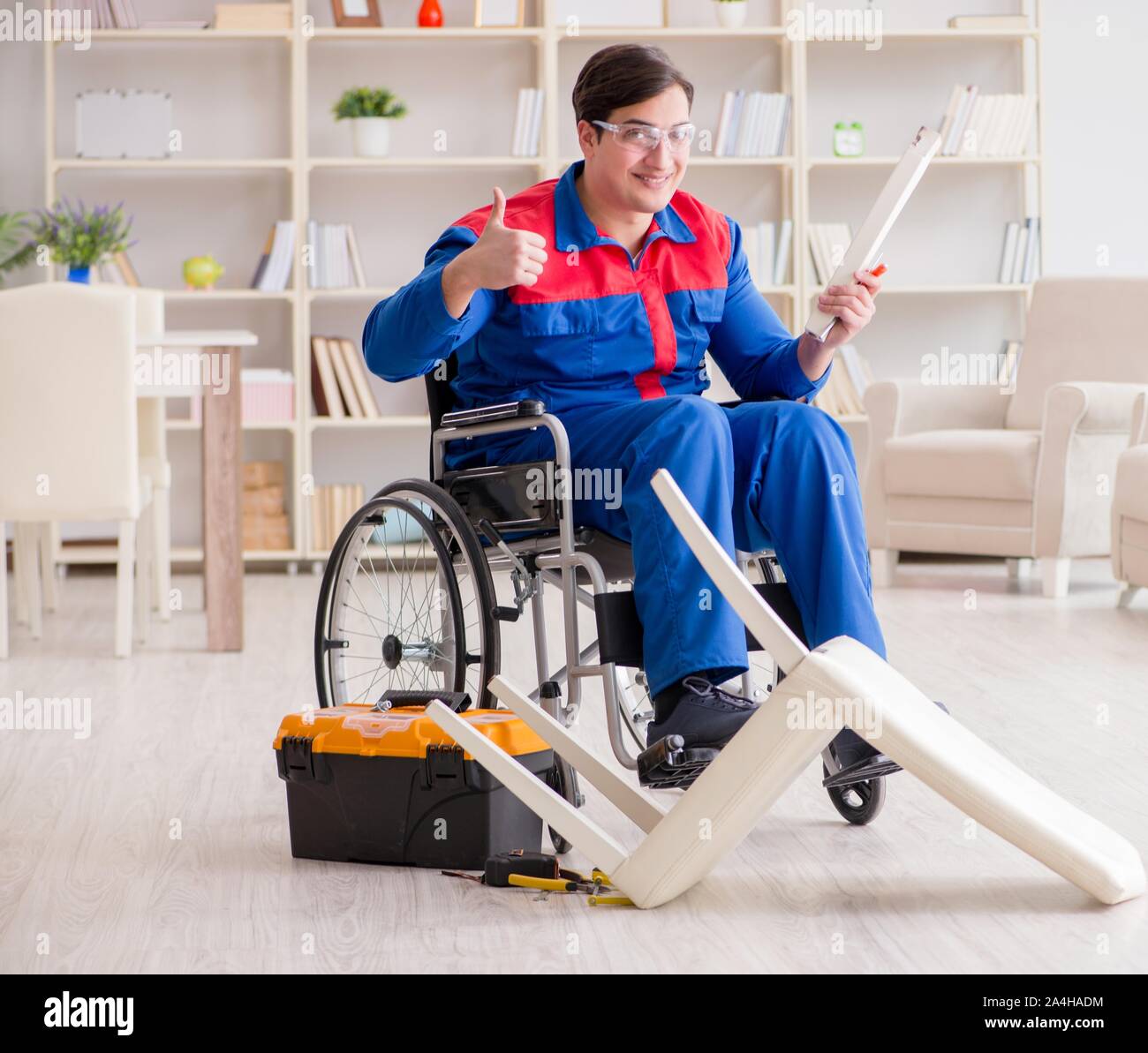The disabled man repairing chair in workshop Stock Photo - Alamy