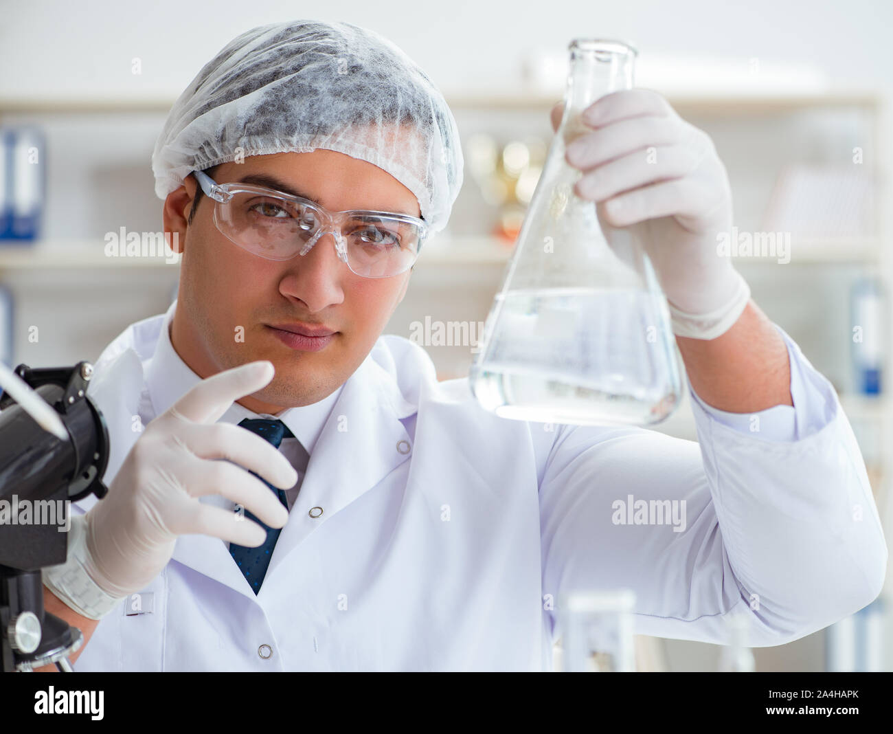 Young researcher scientist doing a water test contamination experiment ...