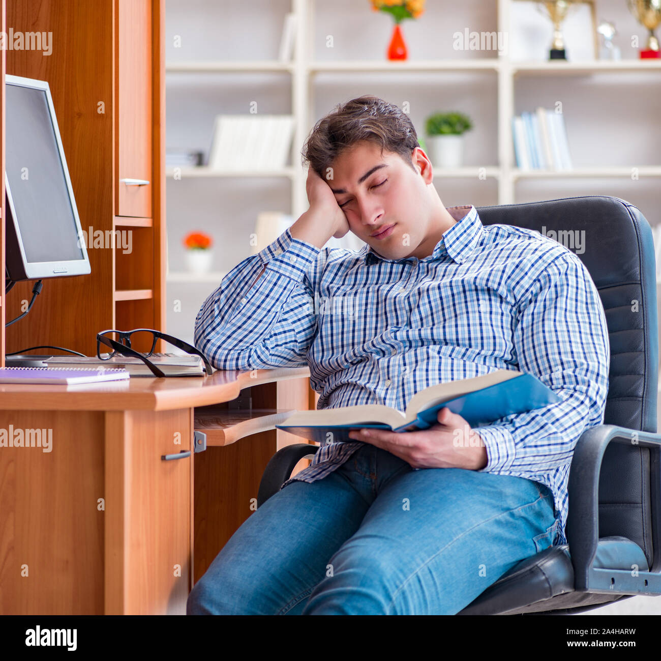 The young student at computer table Stock Photo - Alamy