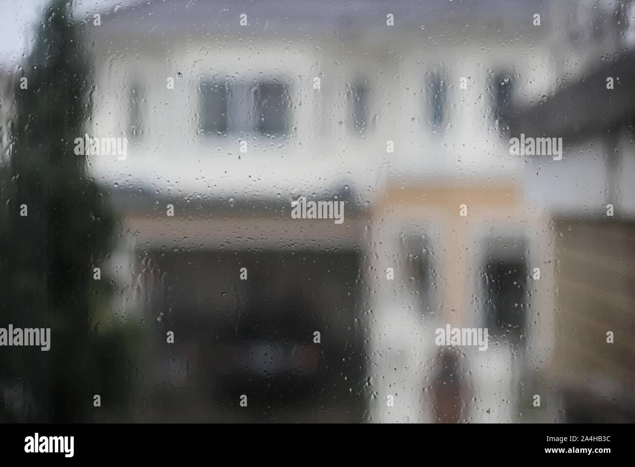 rain water droplets splash caught on glass window. caught in the rain ...