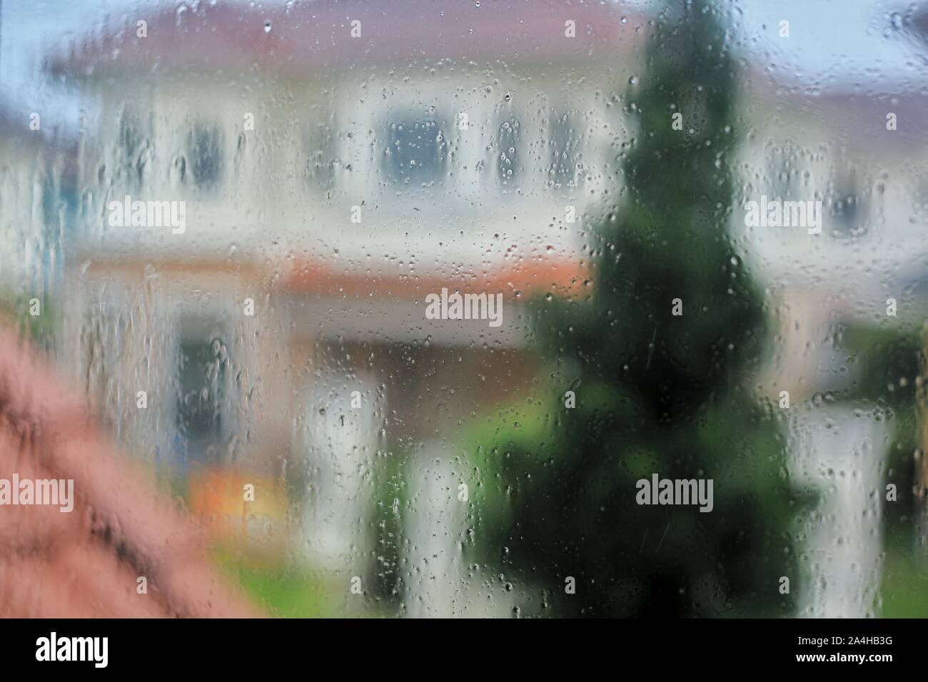 rain water droplets splash caught on glass window. caught in the rain ...