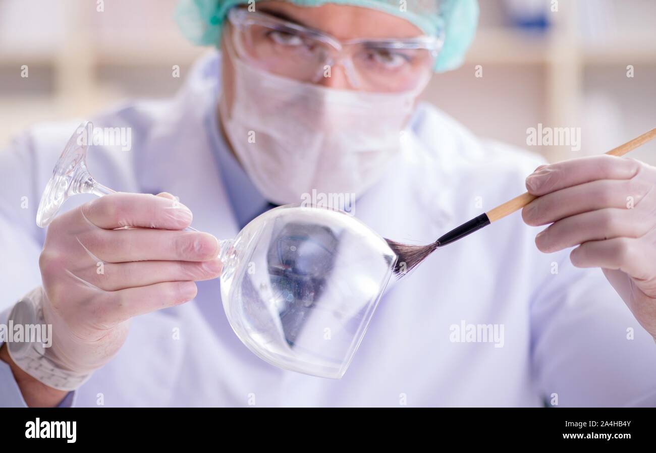 The forensics investigator working in lab on crime evidence Stock Photo ...