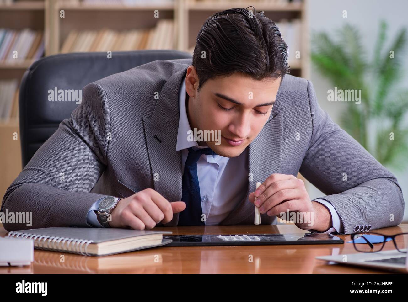 The drug addict businessman in the office Stock Photo - Alamy