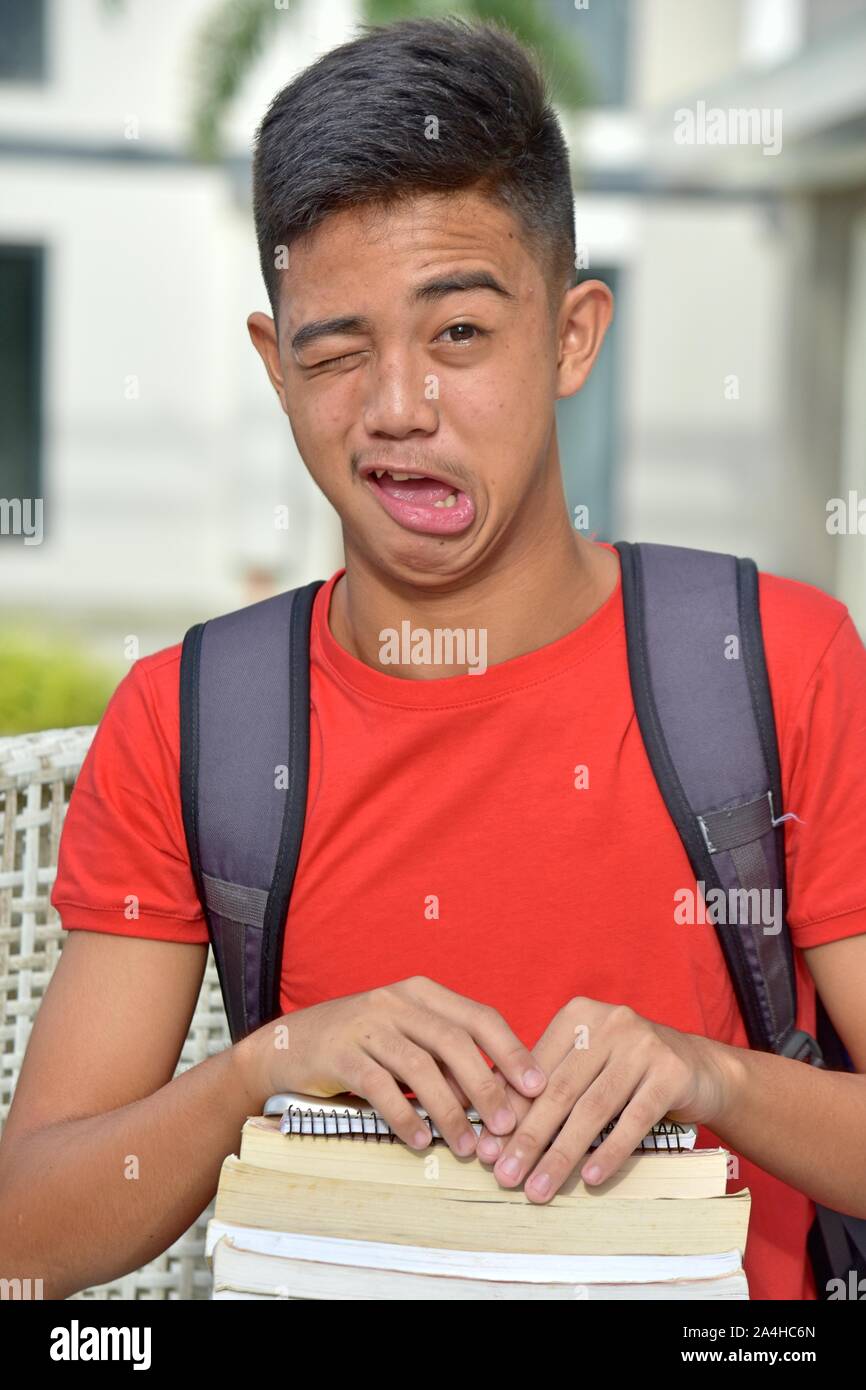 Winking College Filipino Male Student With Books Stock Photo - Alamy