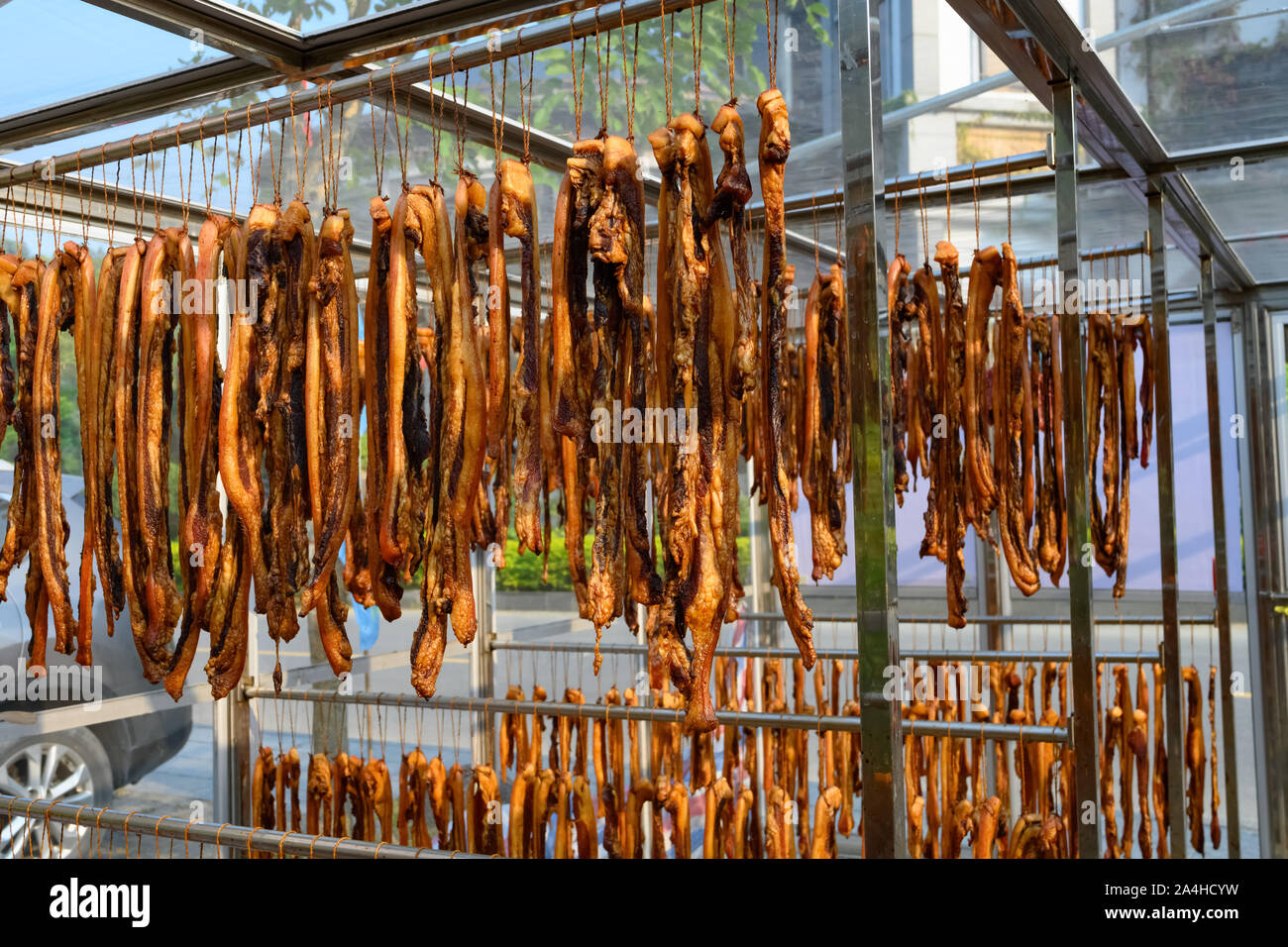 air-dried bacon hanging on shelf and being dried Stock Photo - Alamy