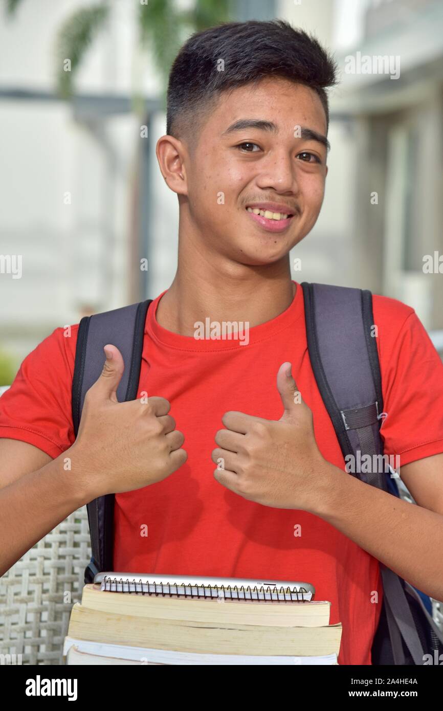 Filipino Student With Thumbs Up With Books Stock Photo - Alamy