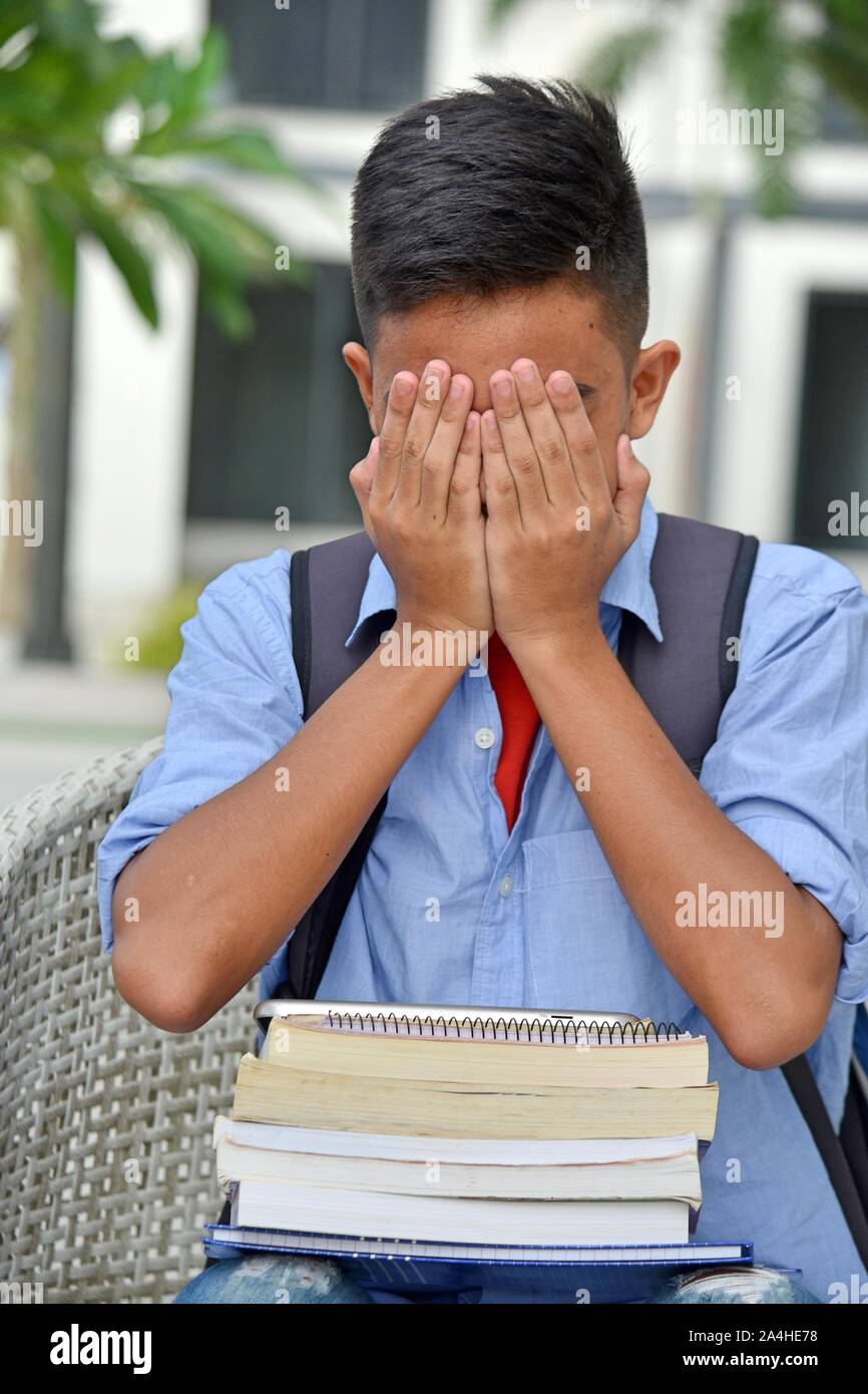 Disappointed Youthful Filipino Boy Student With Notebooks Stock Photo ...