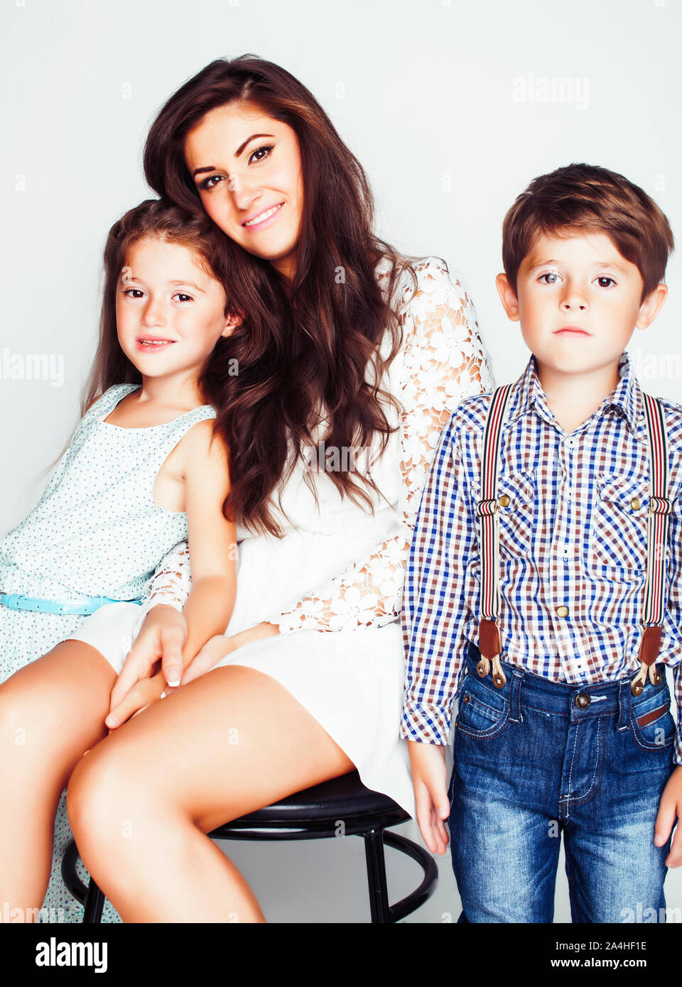 young mother with two children on white background, happy smiling ...