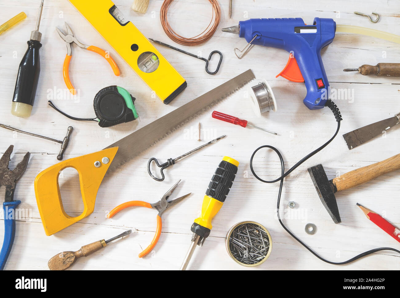 Tools collection on white wooden background Stock Photo - Alamy