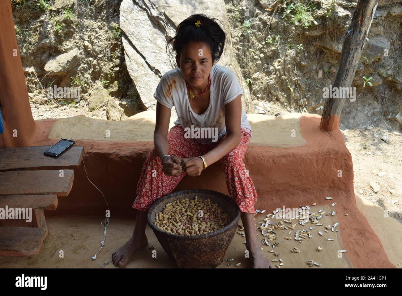 village female eating peanuts Stock Photo - Alamy