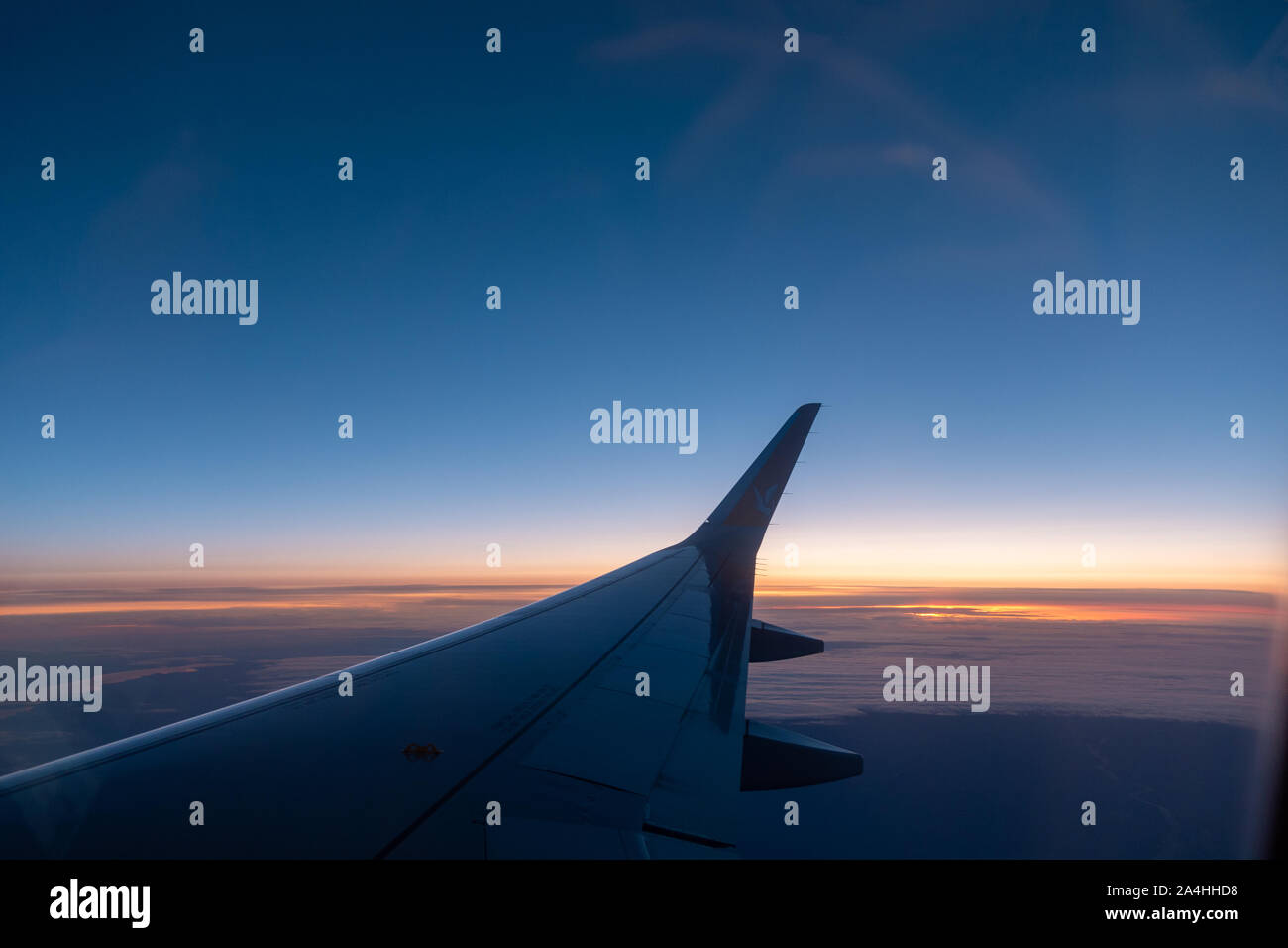the right wing of the plane rises into the blue sky Stock Photo - Alamy