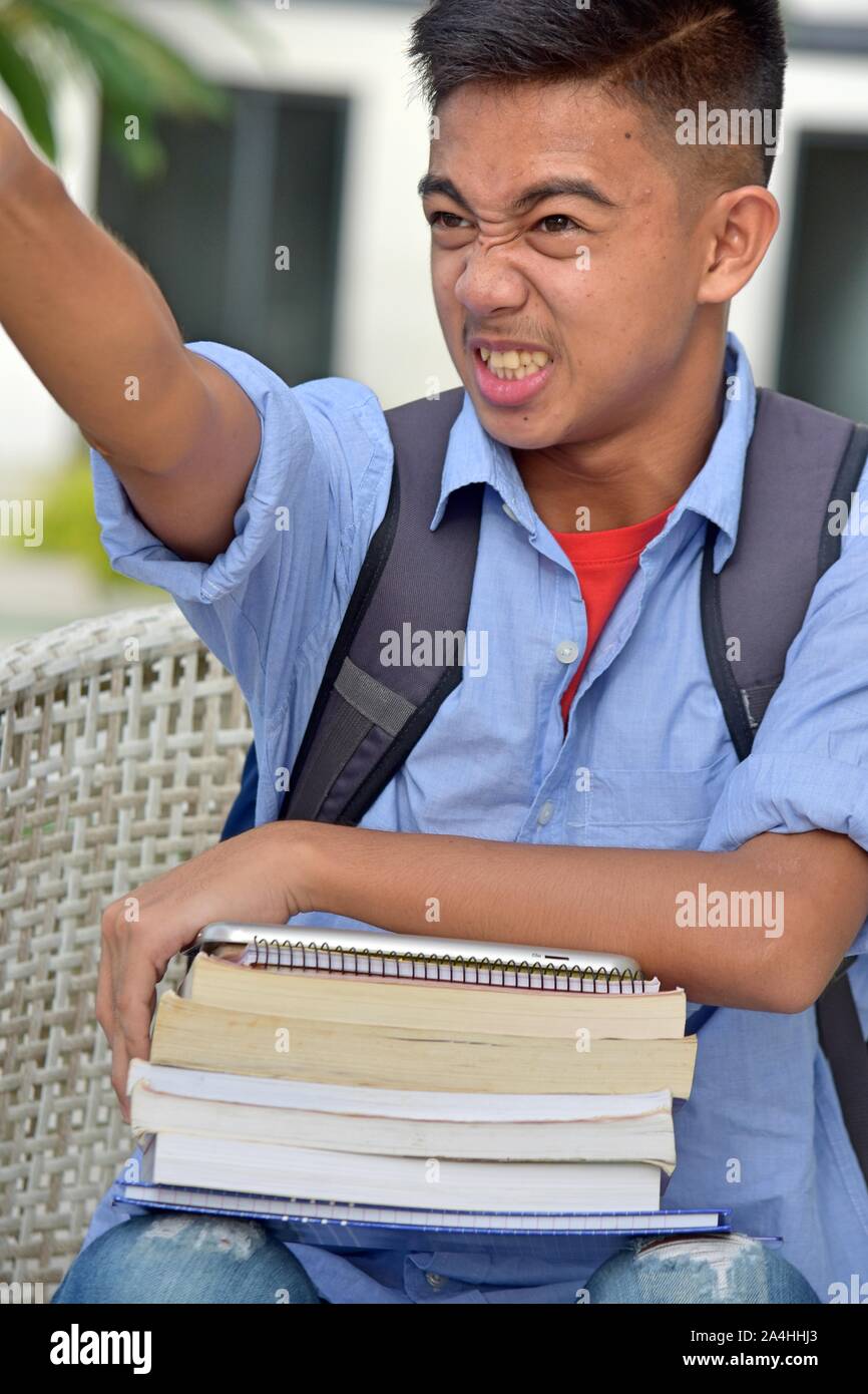 Mad Male Student With Notebooks Stock Photo - Alamy