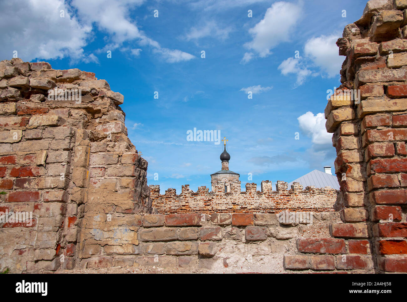 In the doorway of a ruined monastery wall visible to the monastic ...