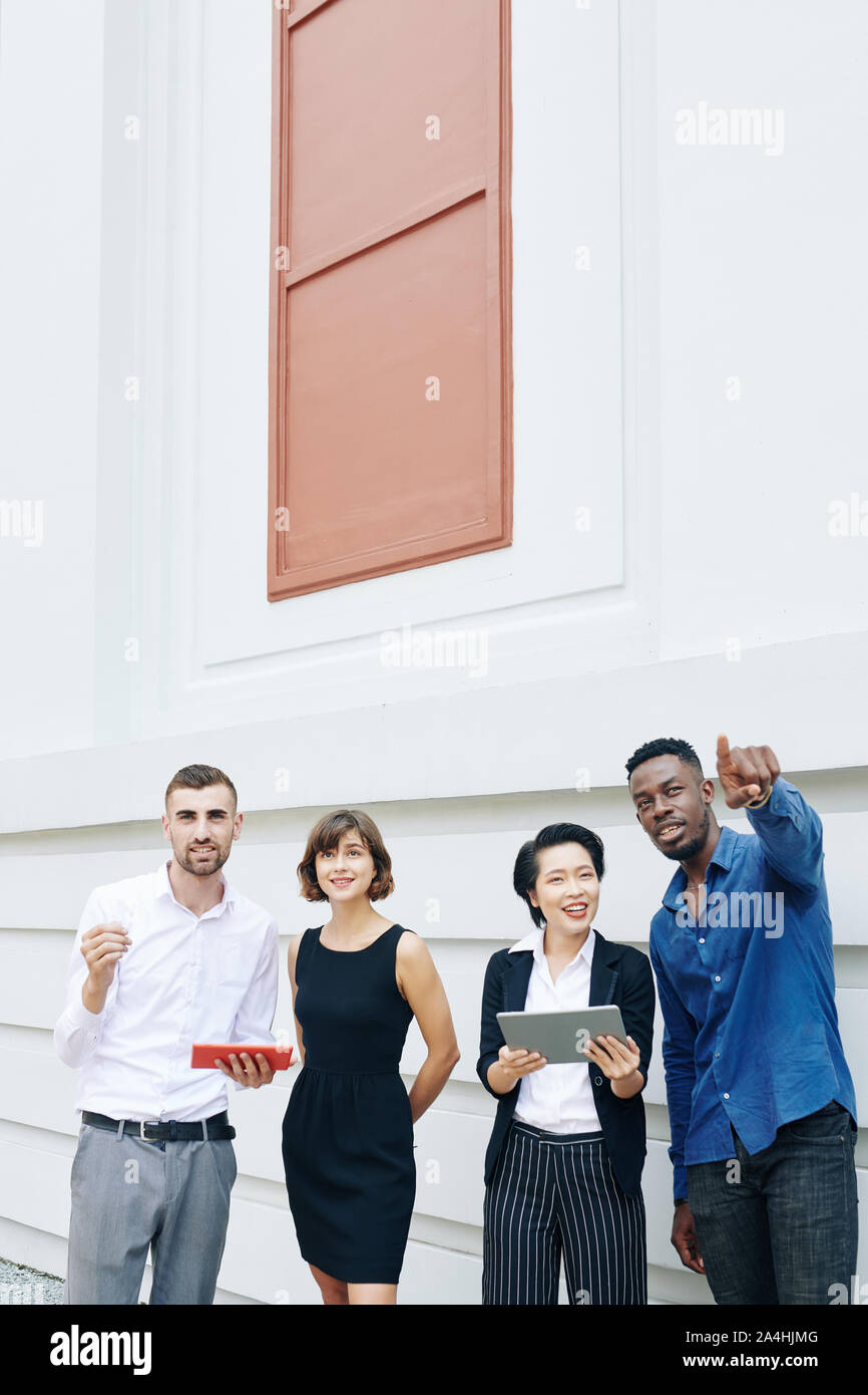 Real estate agents showing new building under construction to investors ...