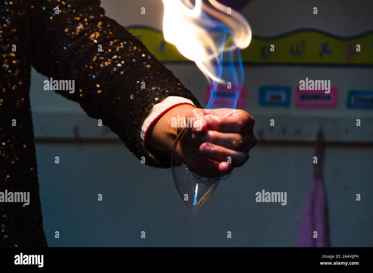 Magician shows trick with fire burn from palms hands Stock Photo - Alamy