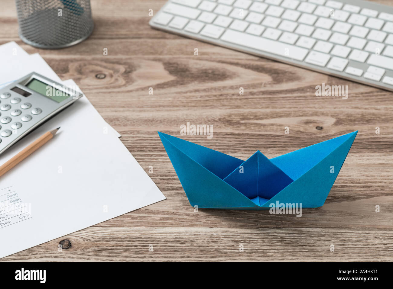 Office workspace with blue paper ship Stock Photo - Alamy