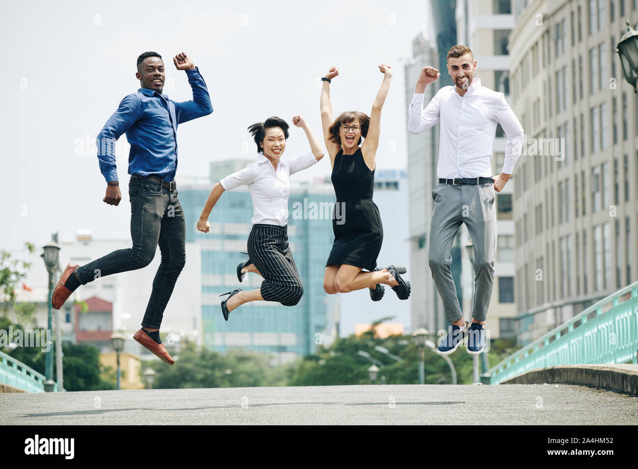 Happy excited multi-ethnic business people jumping in the air when ...