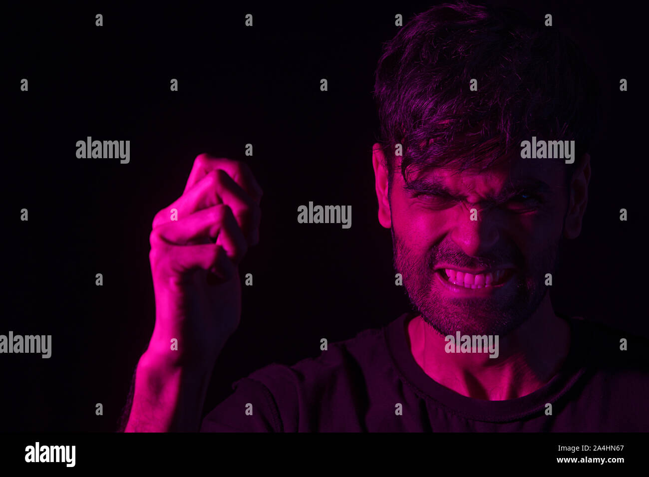 portrait of an angry man with clenched teeth in red Stock Photo - Alamy