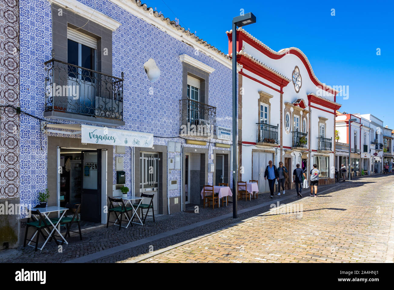 Colorful street in Tavira with a typical Portuguese house covered with ...
