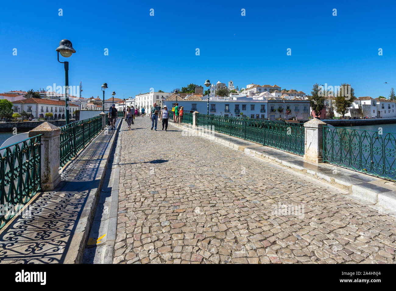 Pedestrian cobbled bridge know as Roman Bridge (Puente Romano) crossing ...