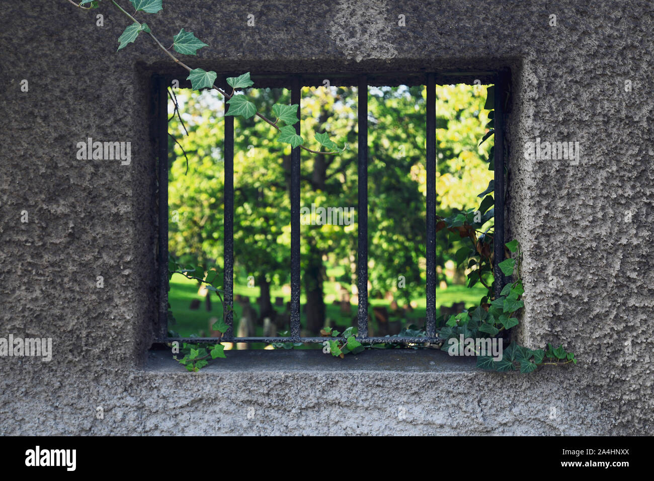 Stone wall with window with iron bars and view on blurry Jewish ...