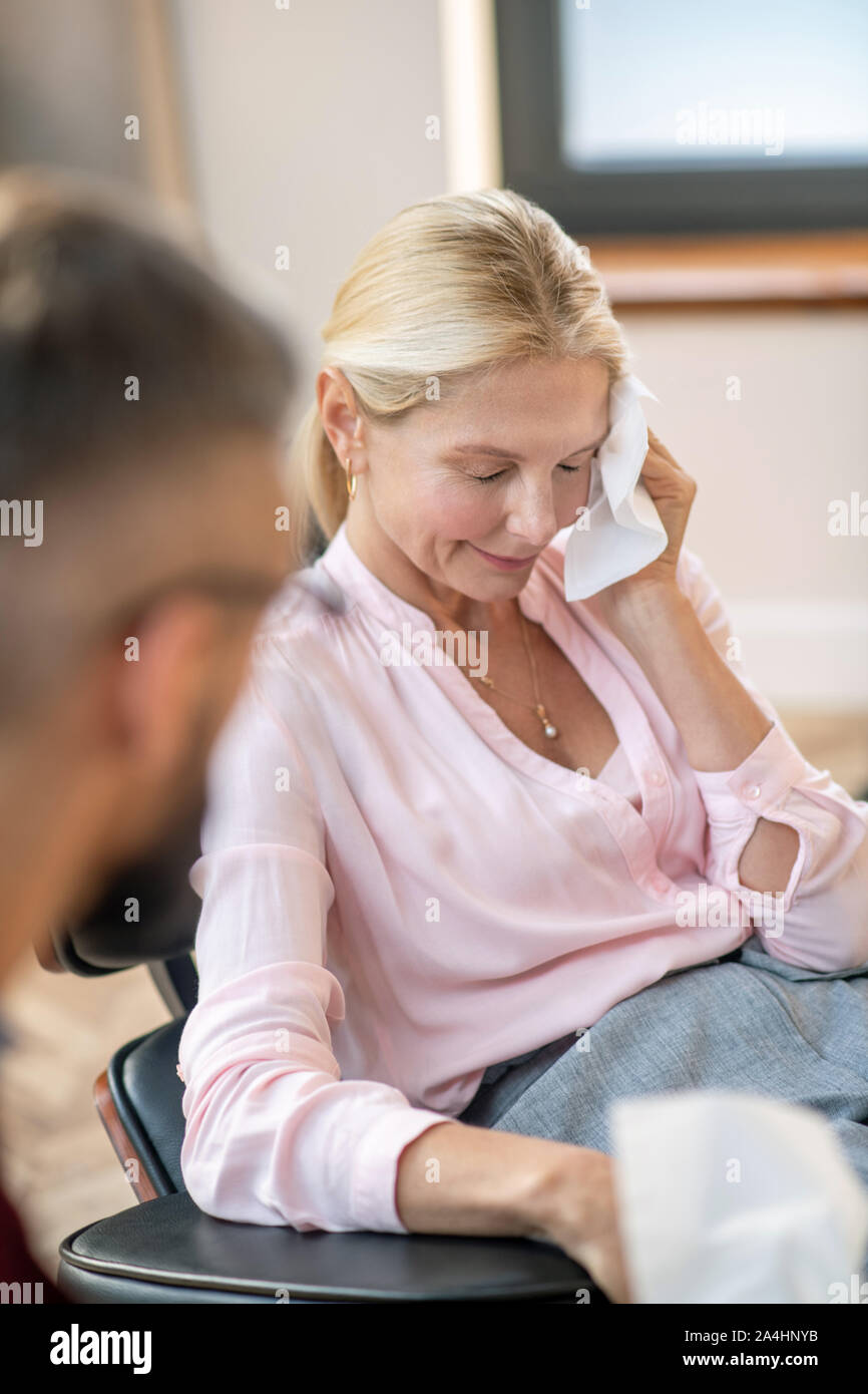 Woman wearing stylish blouse crying while feeling stressed Stock Photo ...