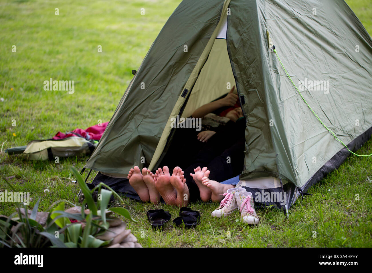 Bare feet sticking out of a tourist tent Stock Photo - Alamy
