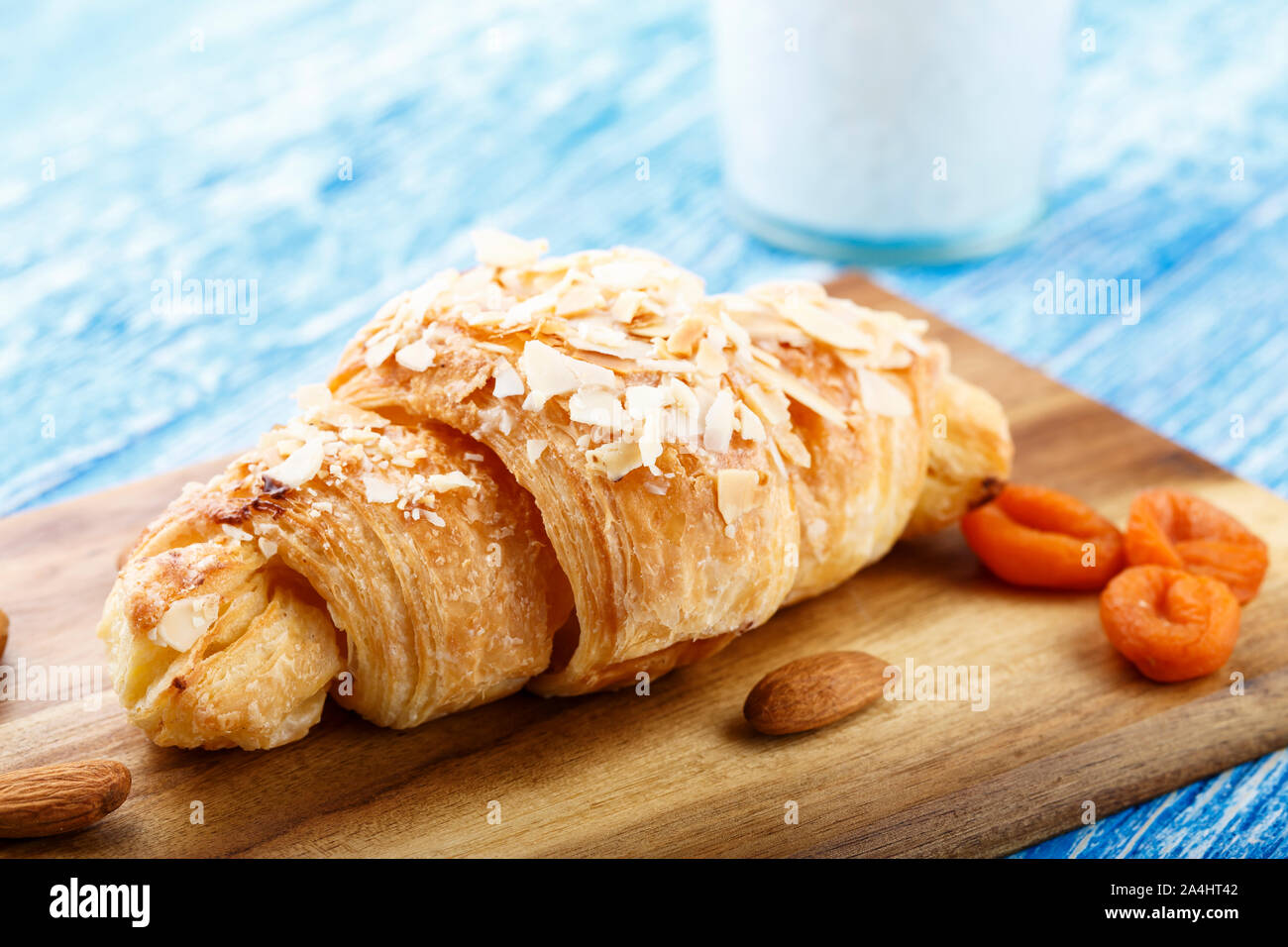 Fresh croissant and dried fruits on the table. traditional carbohydrate ...