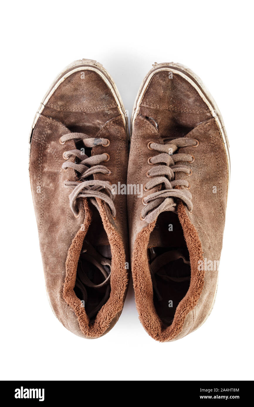 Old and dirty brown sneakers isolated on white background. Top view ...