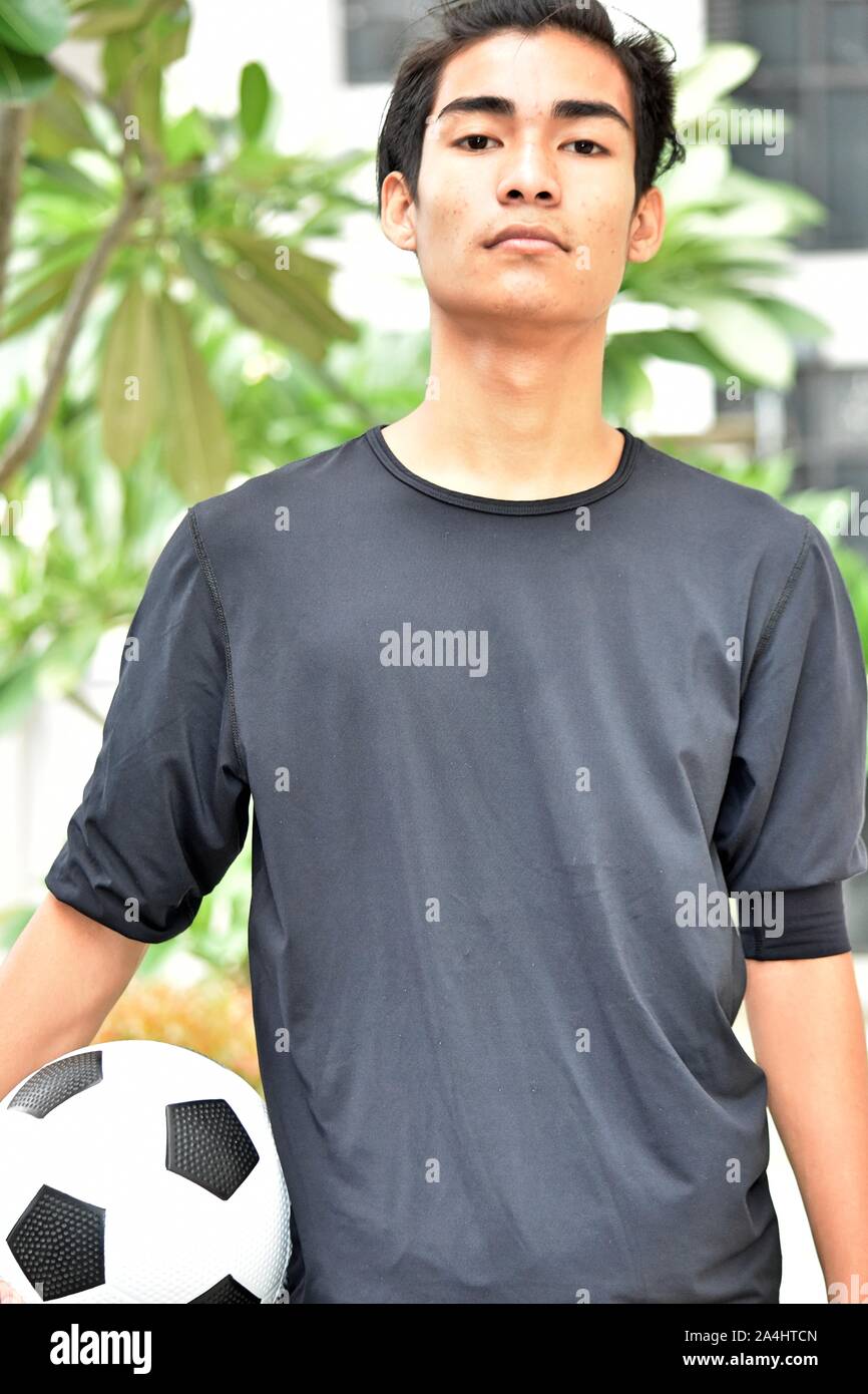 Unemotional Athletic Filipino Male Soccer Player With Soccer Ball Stock ...