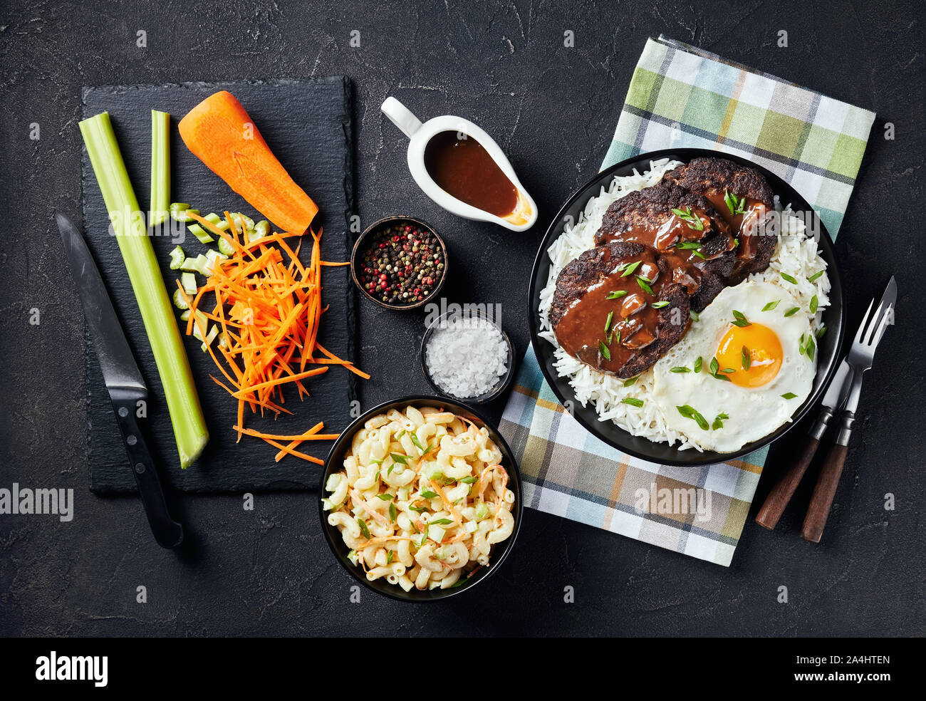 overhead view of loco moco of white rice with burger patties, a fried ...