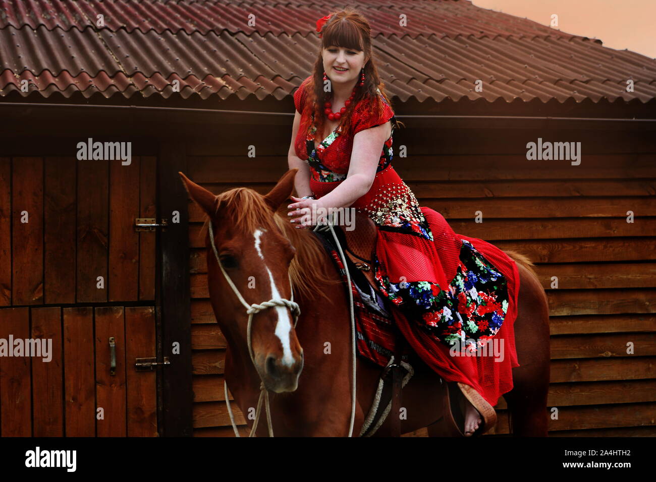 Beautiful young gypsy woman riding a horse Stock Photo - Alamy