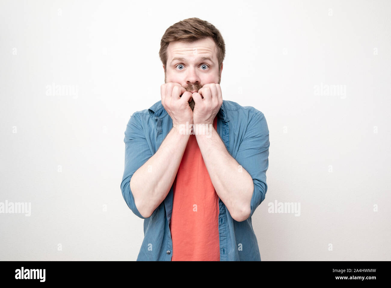 Surprised excited man, with expression of shock on his face and hands ...