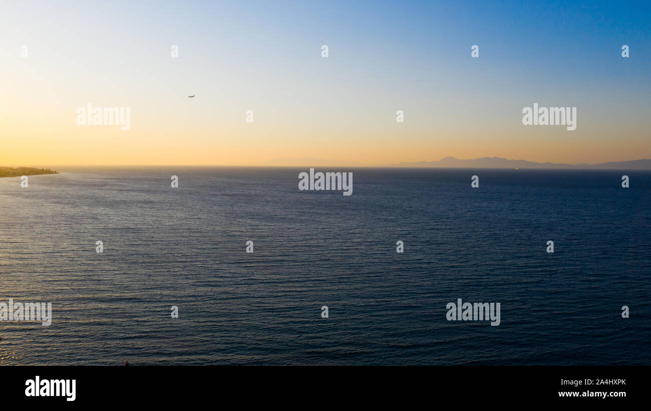 aeroplane flying over ocean Stock Photo - Alamy